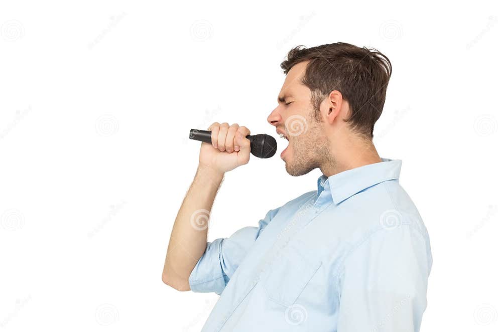 Side View of a Young Man Singing into Microphone Stock Photo - Image of ...