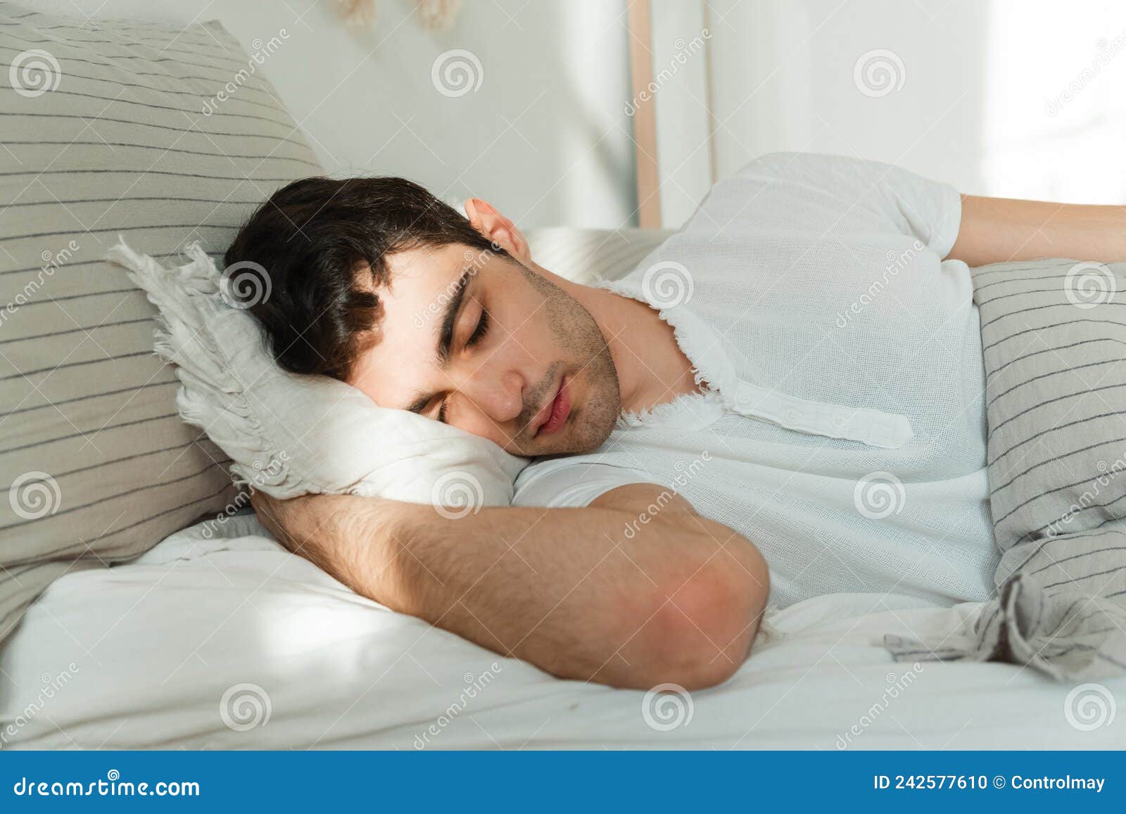 Side View of a Young Man Sleeping on the Bed in the Bedroom. the ...