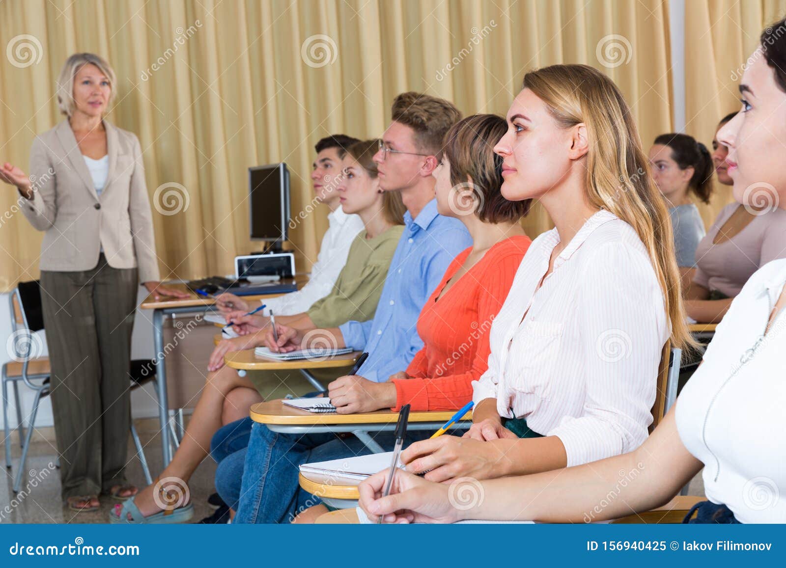 Side View of Young People with Female Lecturer in Auditorium Stock ...
