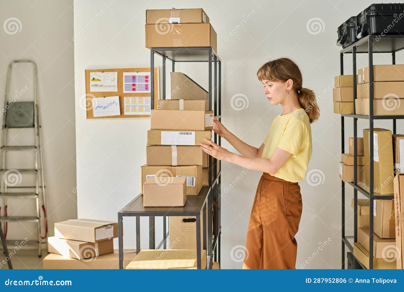 Side View of Young Pretty Manager of Storage Room Standing in Front of ...