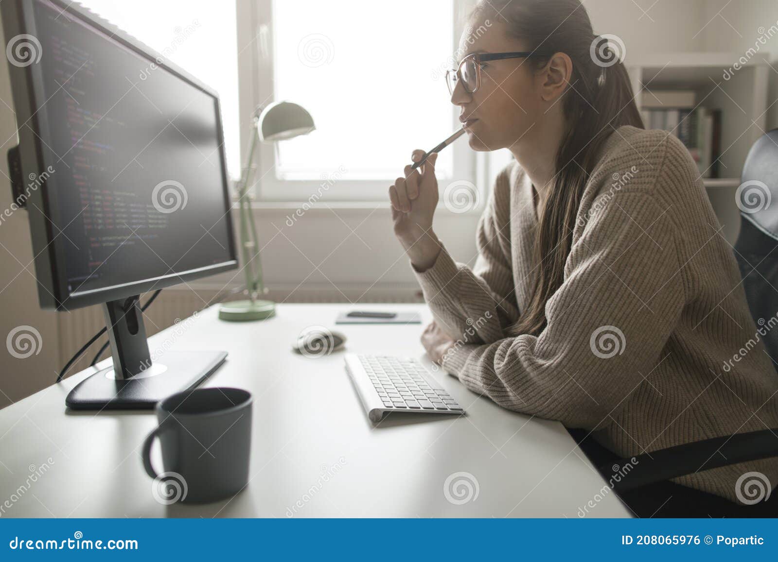 Side View of Young Programmer Working on Computer Codes from Her Home ...