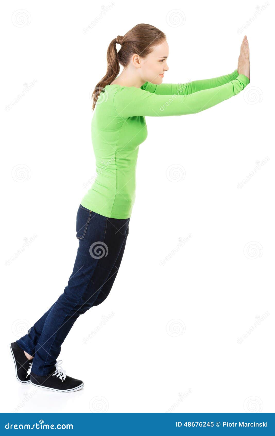 Side View of Young Woman Pushing an Abstract Wall Stock Image - Image ...
