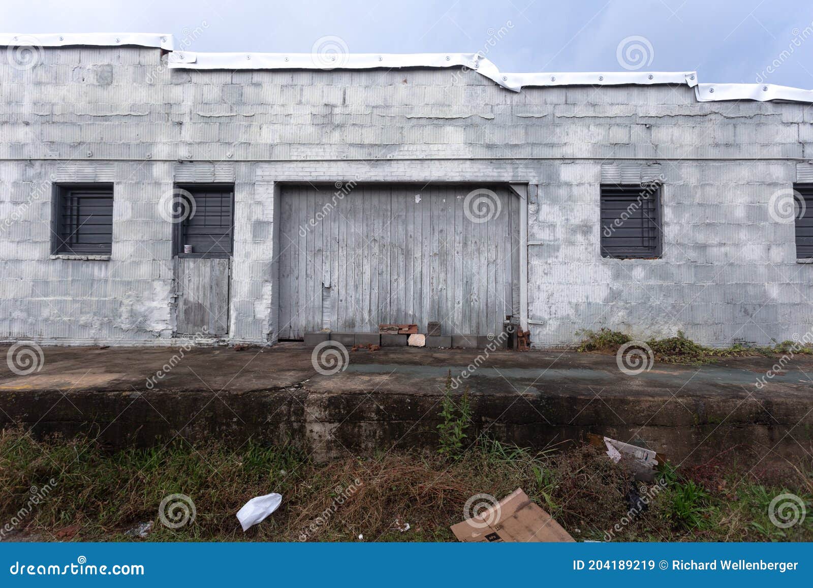 Side of Vintage Abandoned Warehouse and Freight Door with Sky in the ...