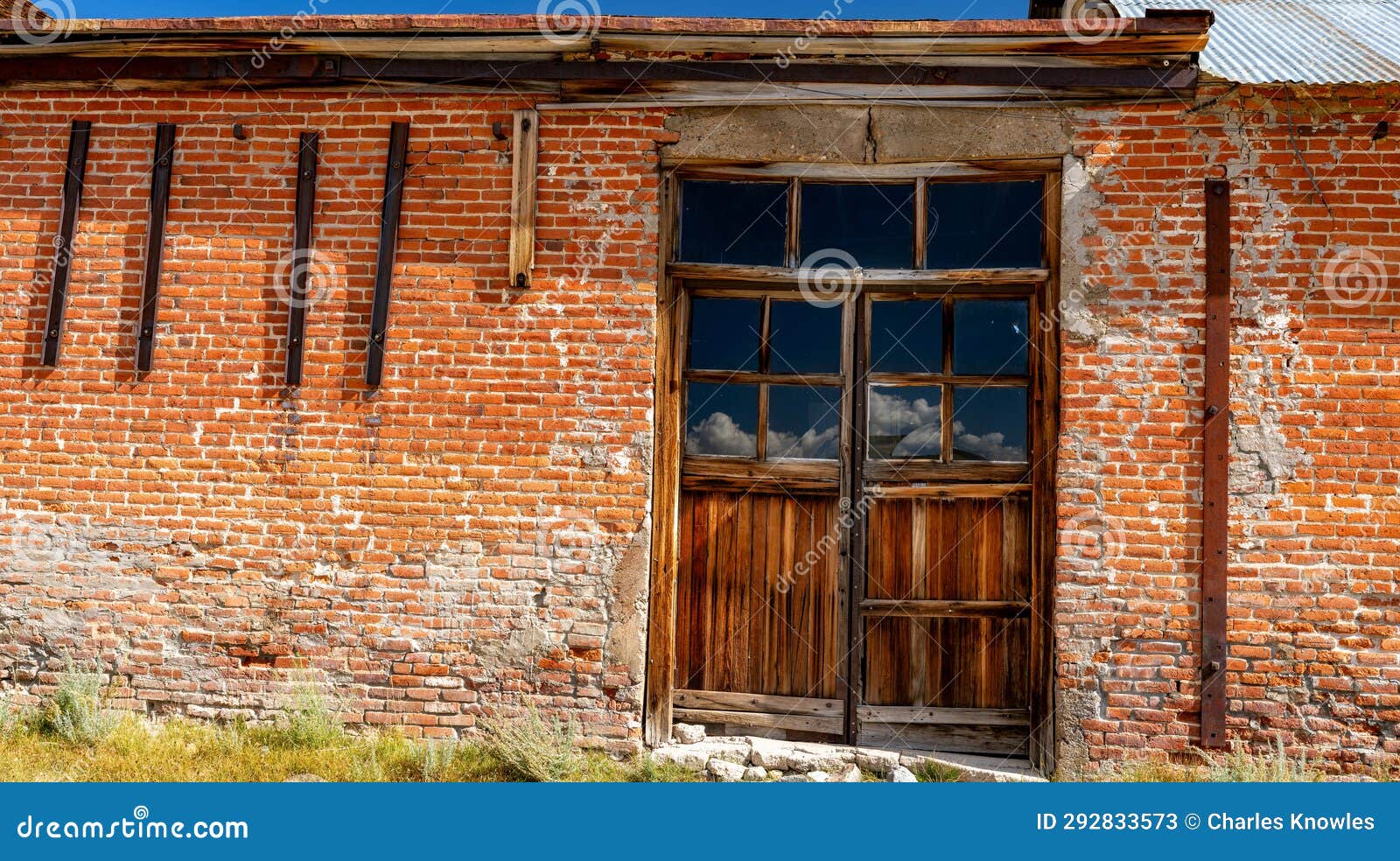 Side Wall of a Brick Building with Wood Door Stock Image - Image of ...