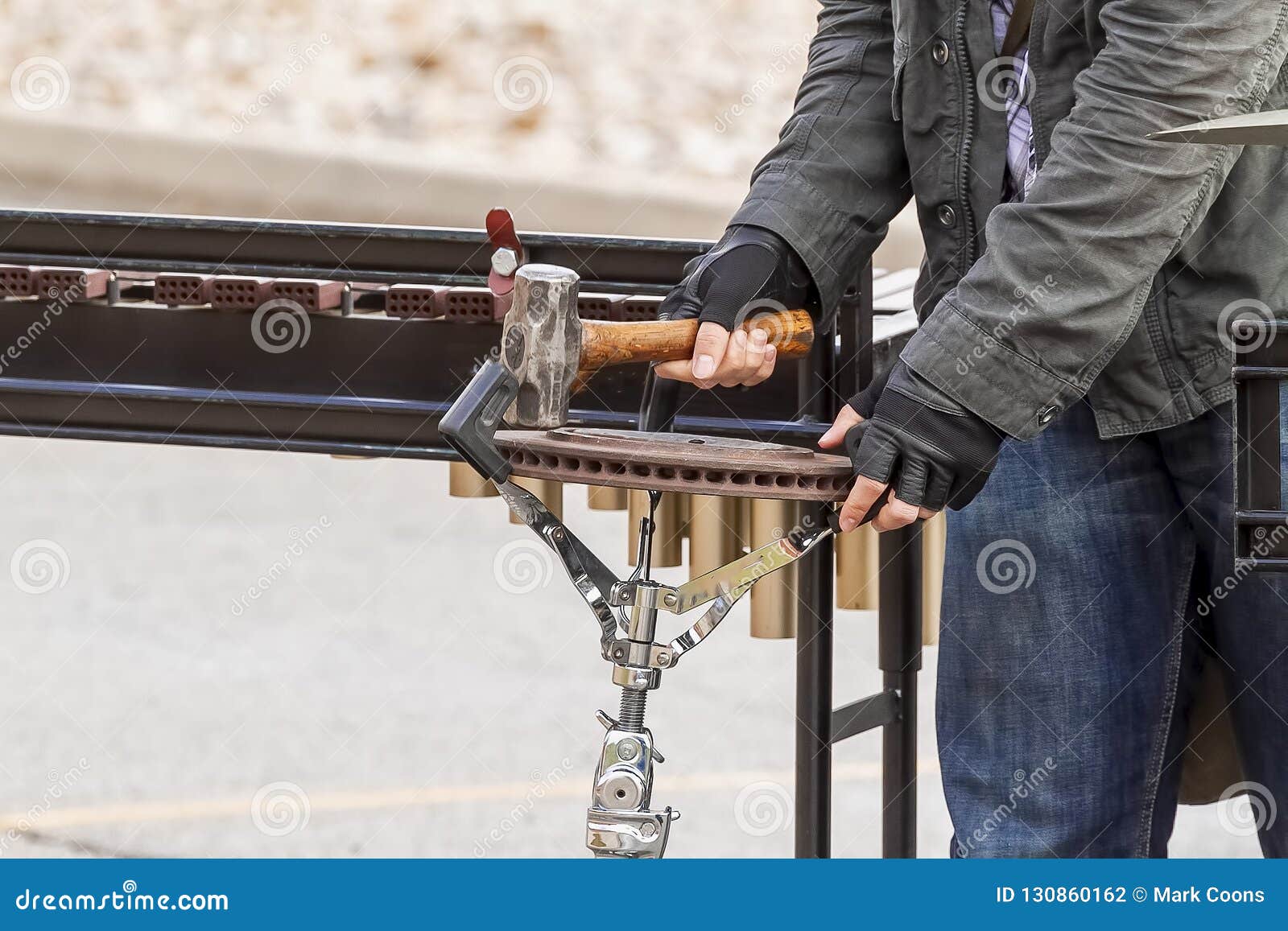 Sideline Percussionist Rapping on a Metal Plate with a Hammer Stock ...