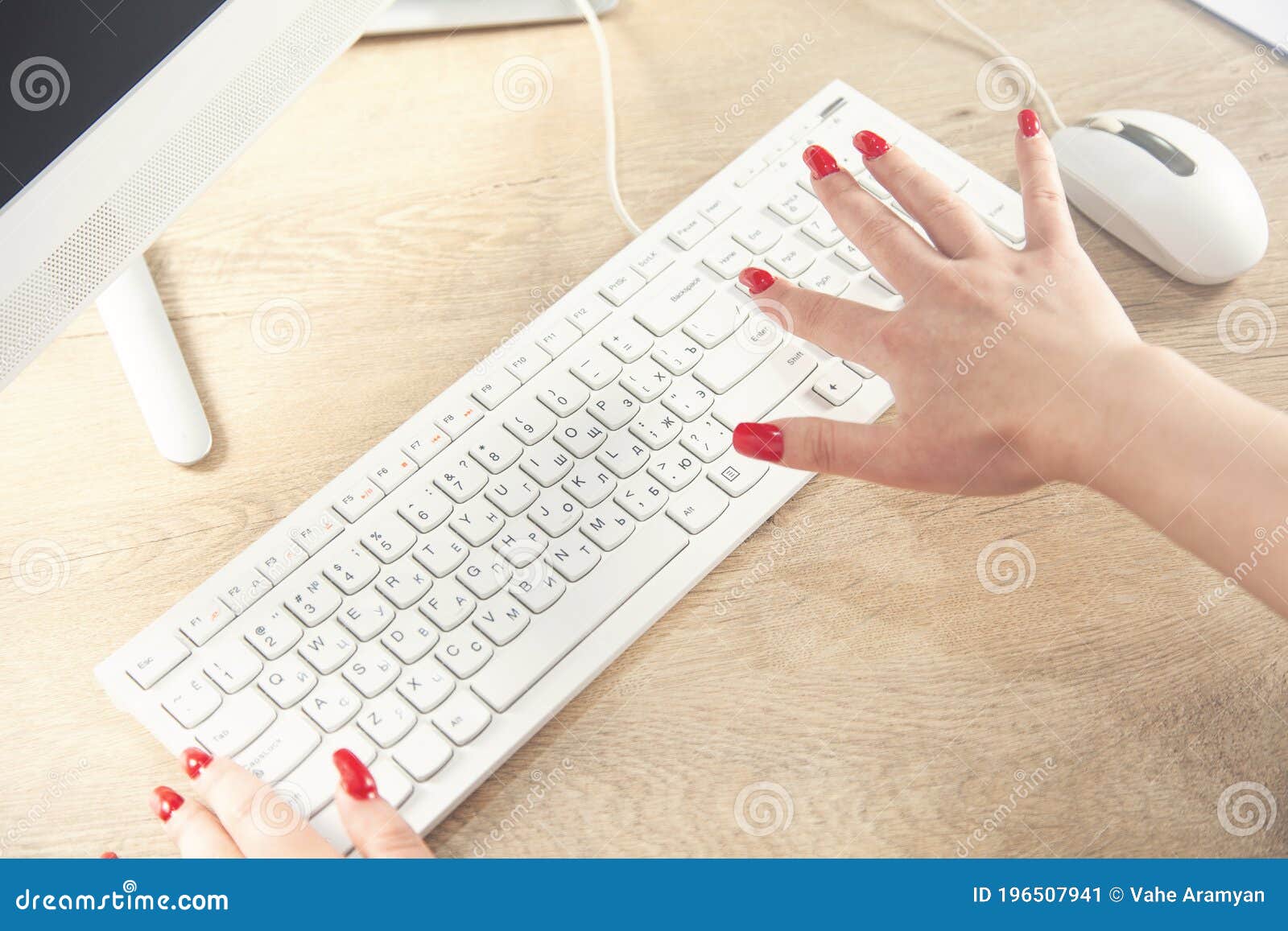 Sideview of Female Hands Using Computer on Table with Glasses and Other ...