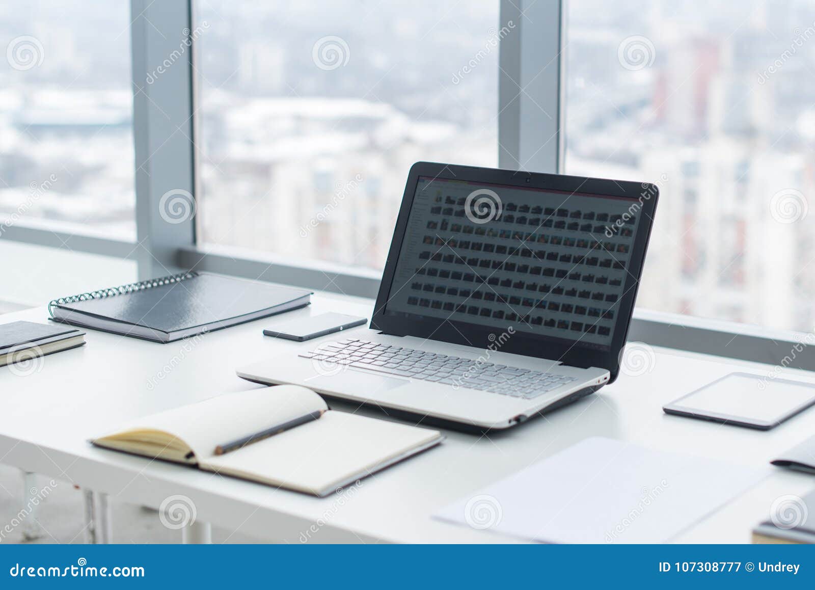 Sideview of Office Desktop with Blank Laptop and Various Tools. Stock ...