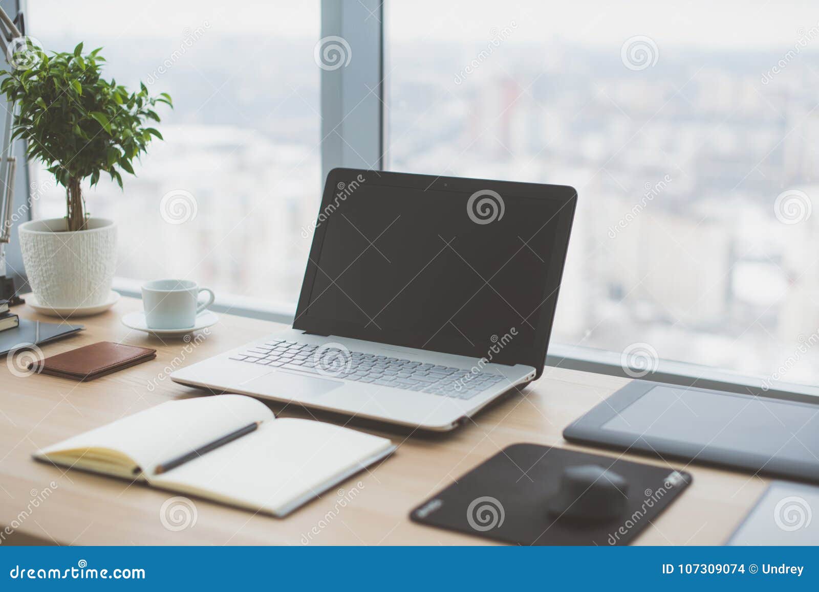 Sideview of Office Desktop with Blank Laptop and Various Tools. Stock ...