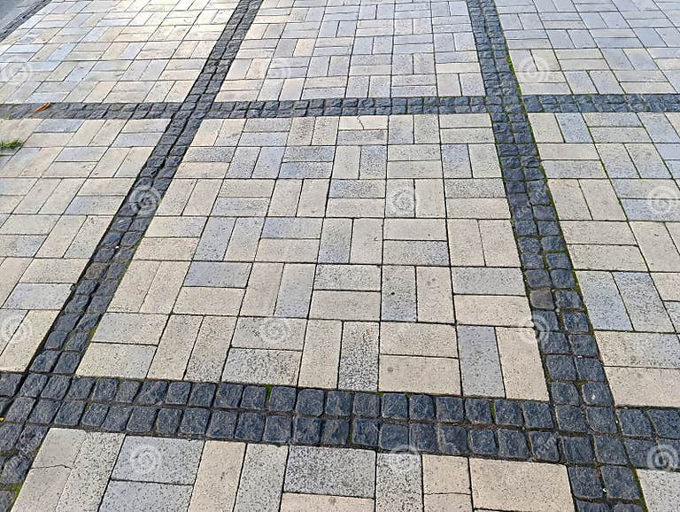 A Sidewalk with a Black and White Tiled Pattern on it Stock Photo ...