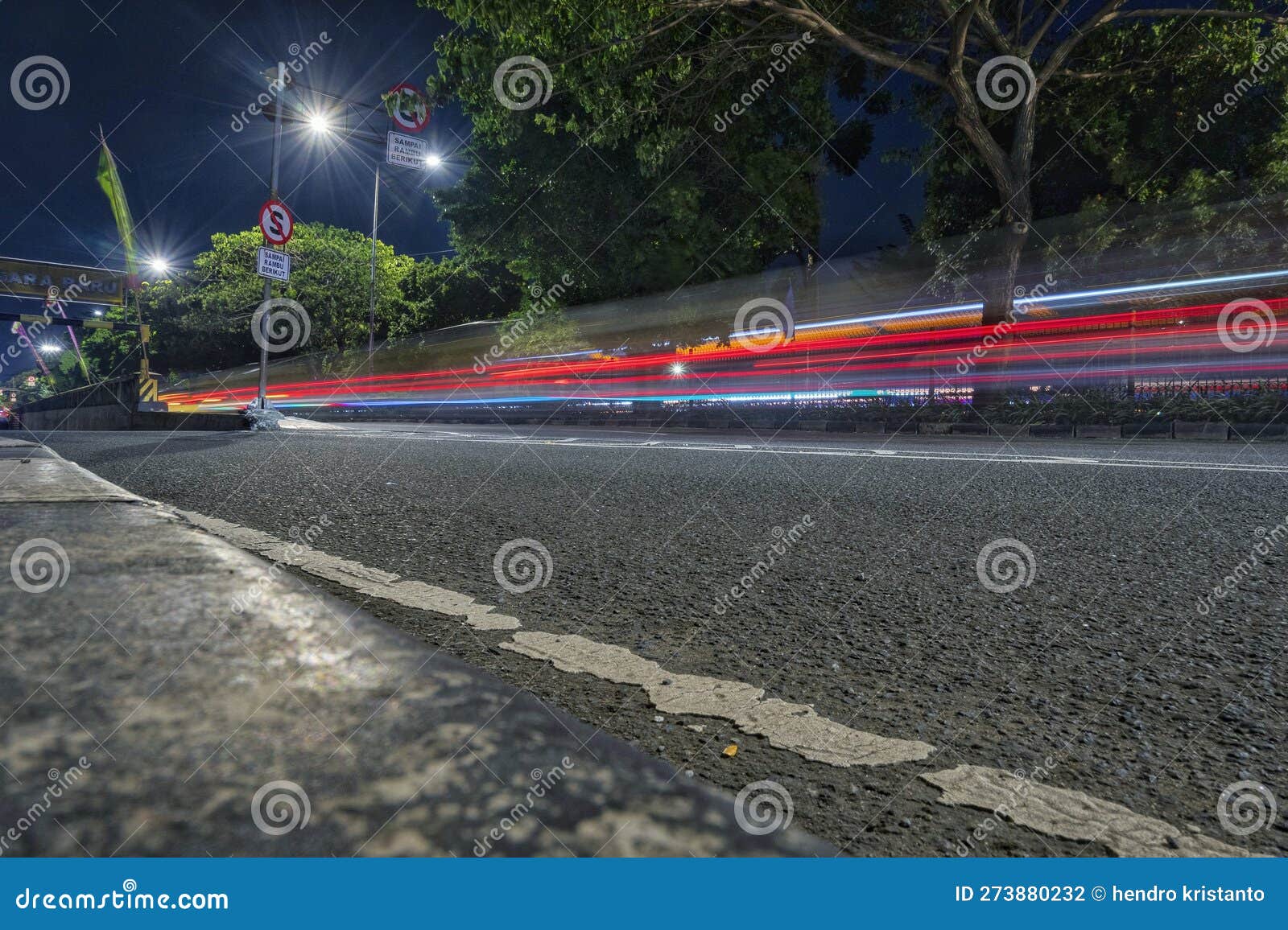 Sidewalk at Night with Light Trails of Passing Vehicles Stock Photo ...