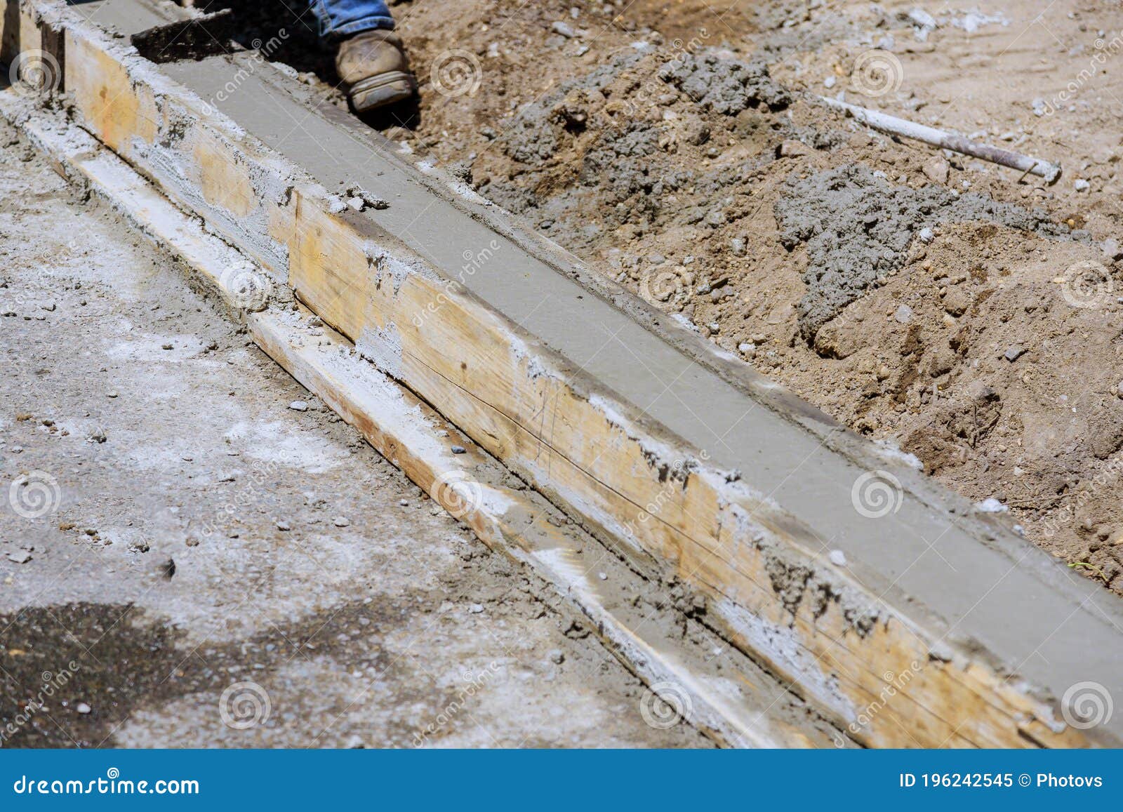 A Sidewalk is Under Construction, a Concrete Curb is Being Installed ...