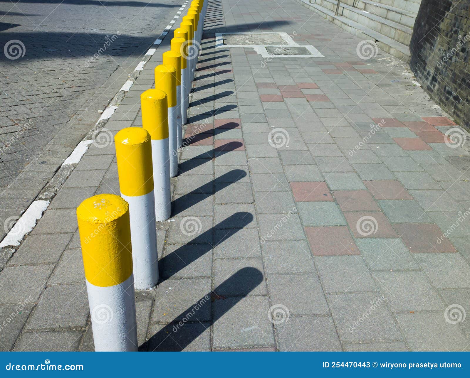 Sidewalk with Yellow and White Poles Barrier Signs Stock Image - Image ...