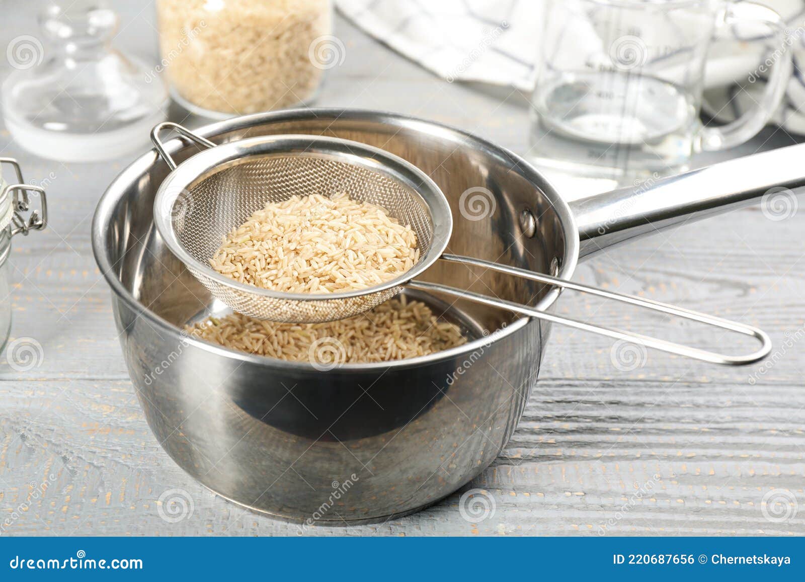 Sieve with Rice in Pot on Grey Wooden Table Stock Photo - Image of ...