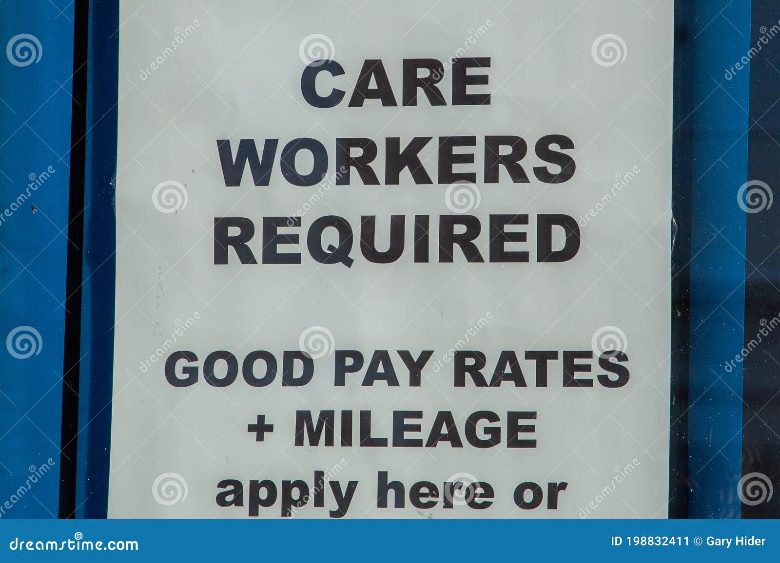 A Sign Advertising a Job in a Window Stating that Care Workers are ...