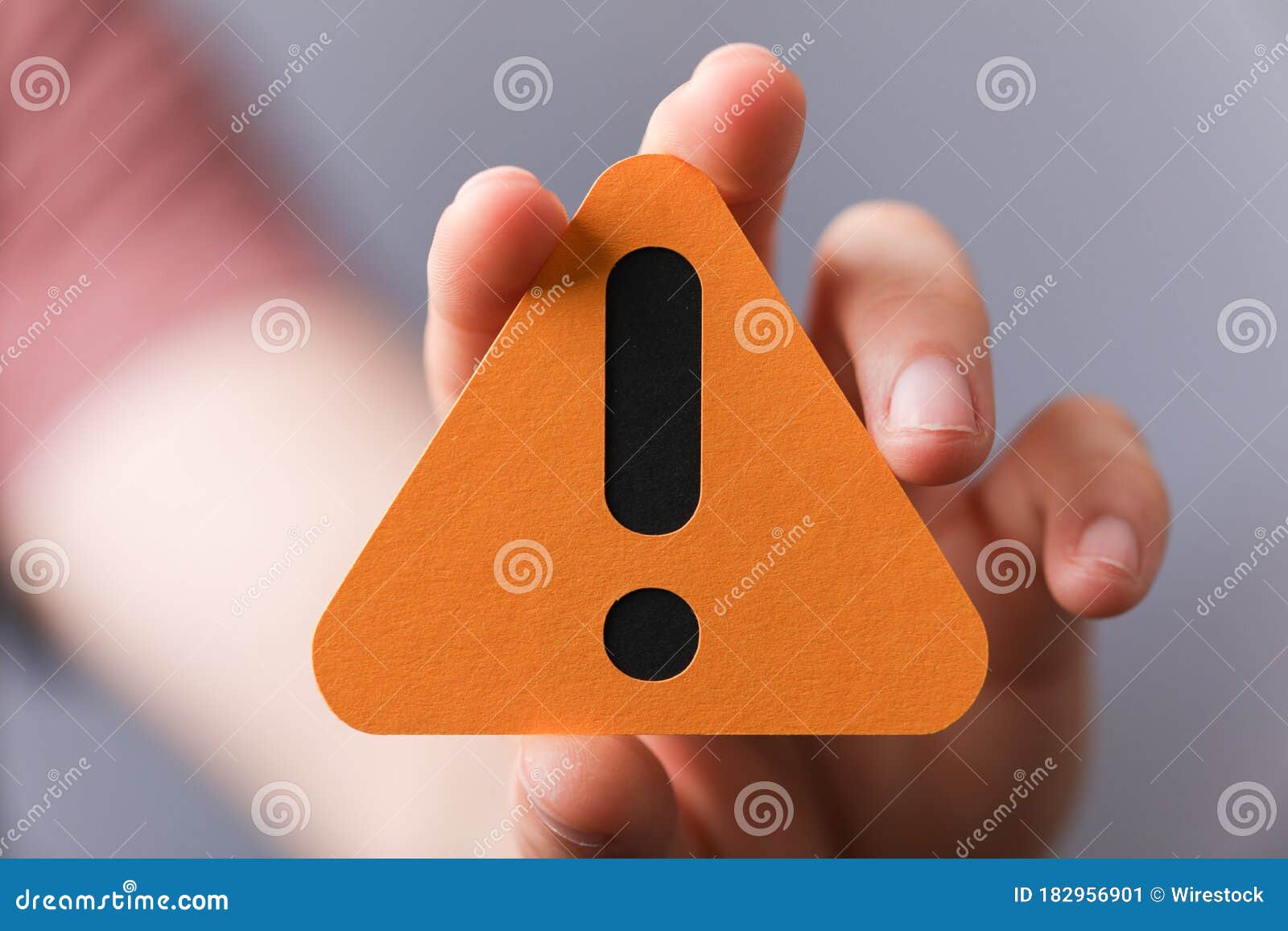 Sign of the Exclamation Mark on a Yellow Paper in the Hands of a Man ...
