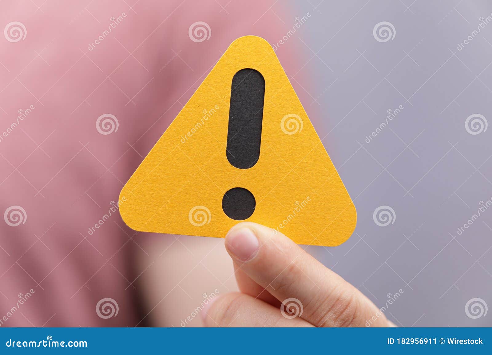 Sign of the Exclamation Mark on a Yellow Paper in the Hands of a Man ...