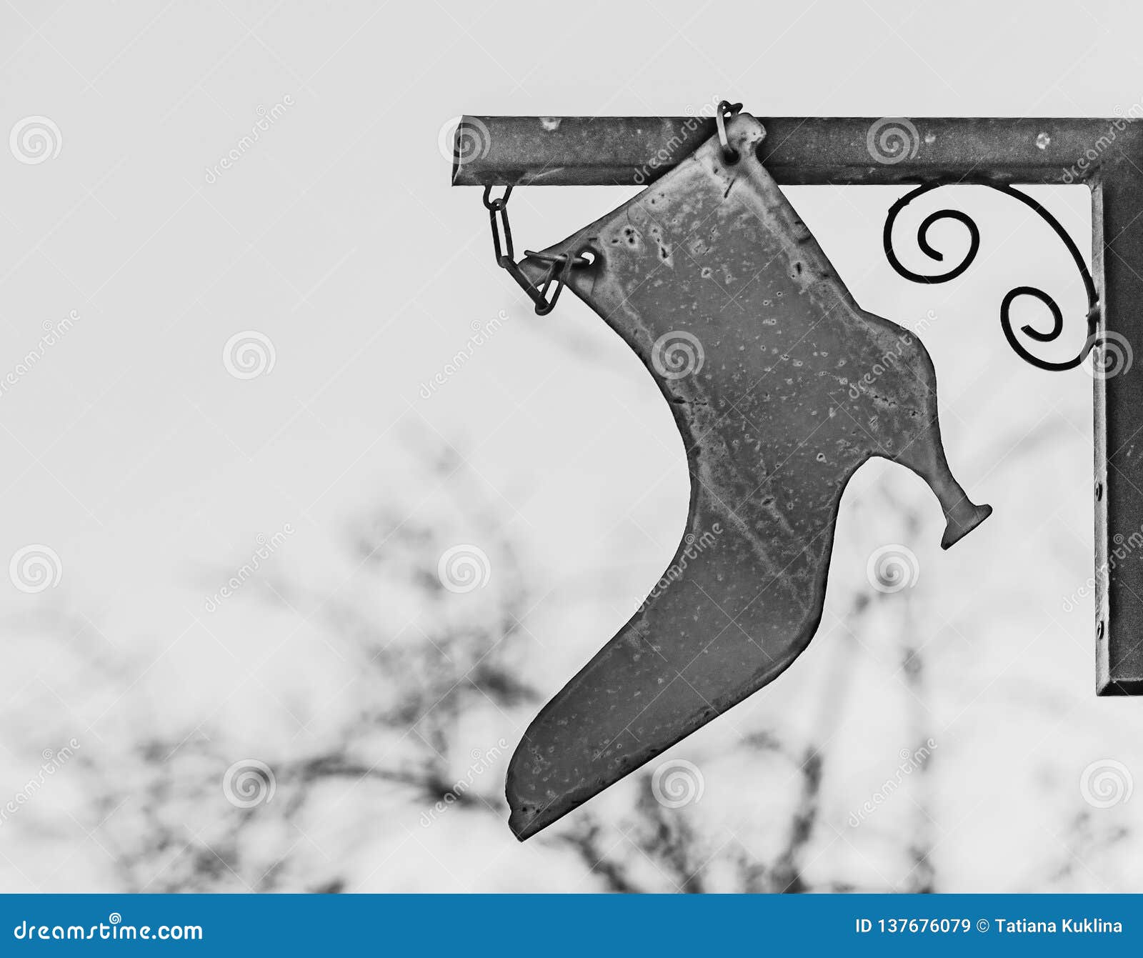 A Sign in the Form of an Old Iron Female Boot with a Sharp Heel on a ...