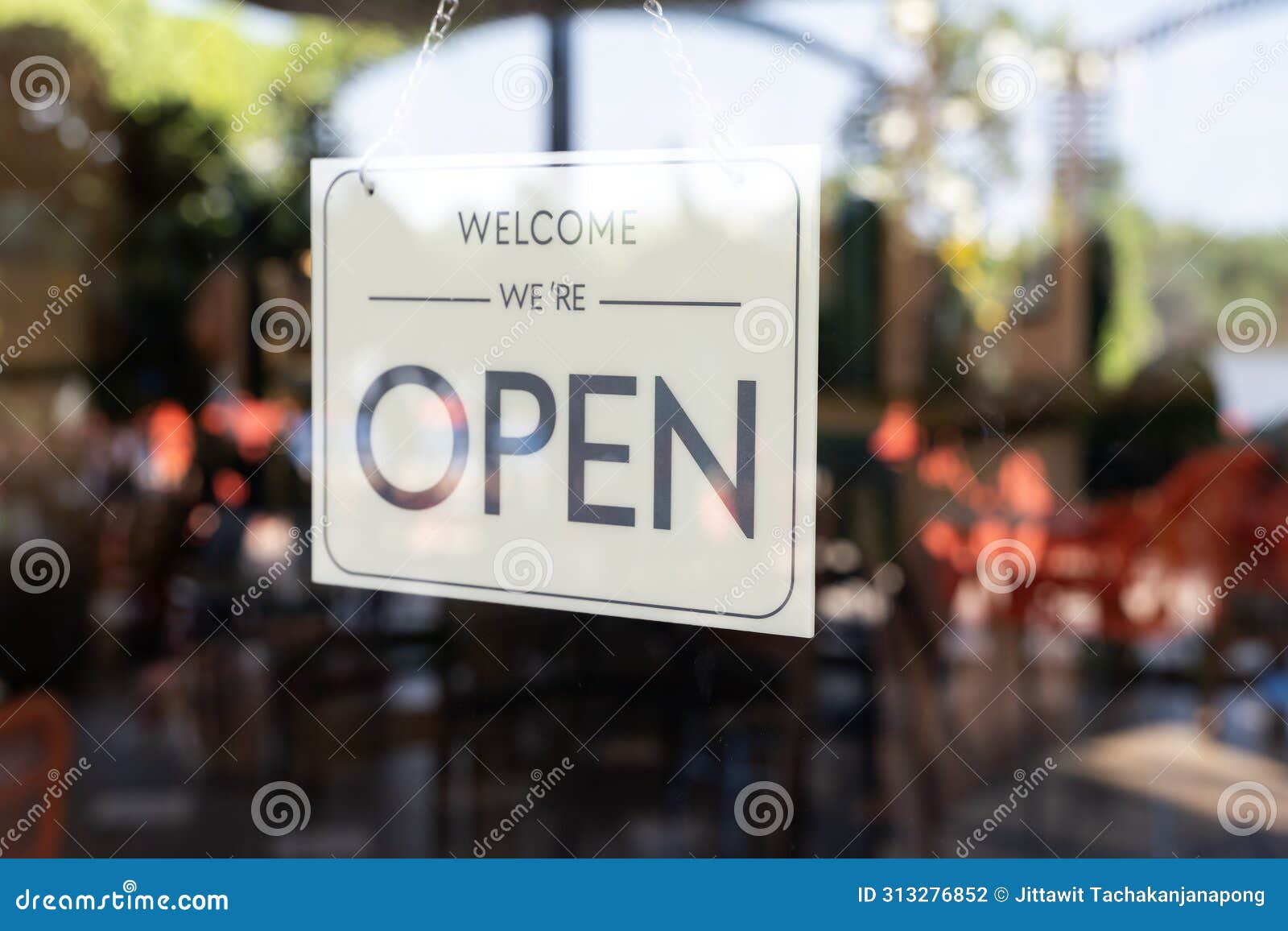 A Sign Hanging from a Window that Says Welcome we Re Open Stock Photo ...