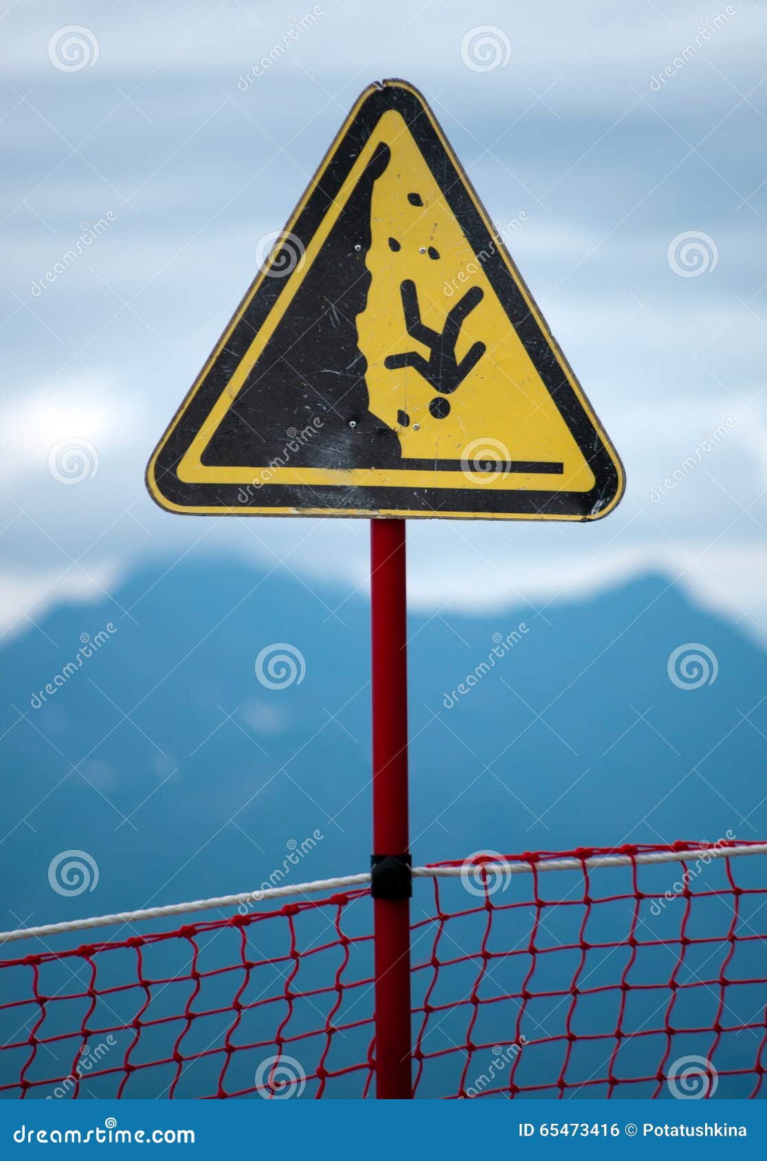 A Sign Indicating the Danger of Falling in the Mountains Stock Photo ...