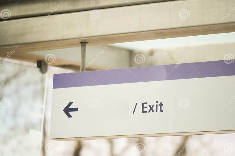 Sign Pointing Left Toward Exit in a Public Space Stock Photo - Image of ...