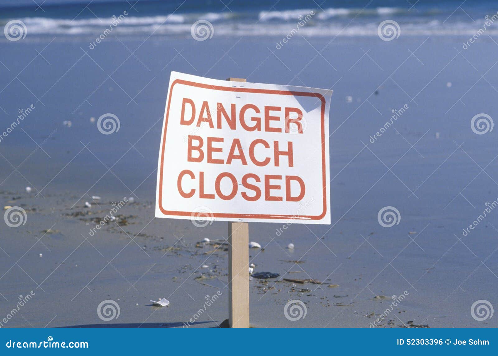 A Sign Reads Danger Beach Closed Stock Photo - Image of ocean, text ...