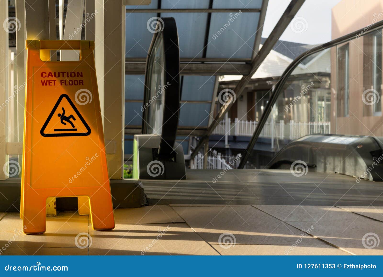 Sign Showing Warning Of Caution Wet Floor On Wet Tile Floor In Sunset ...