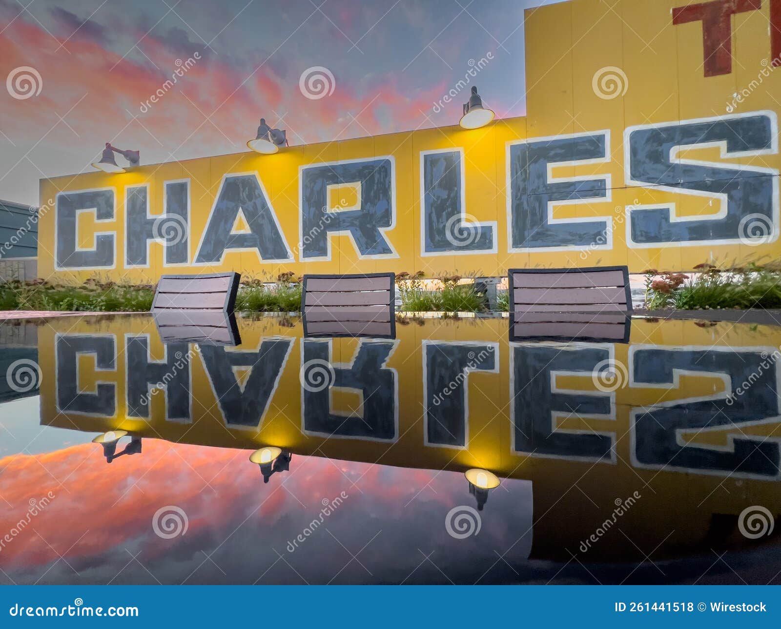 Sign on Top of a Building with Reflection on a Table at Sunset ...