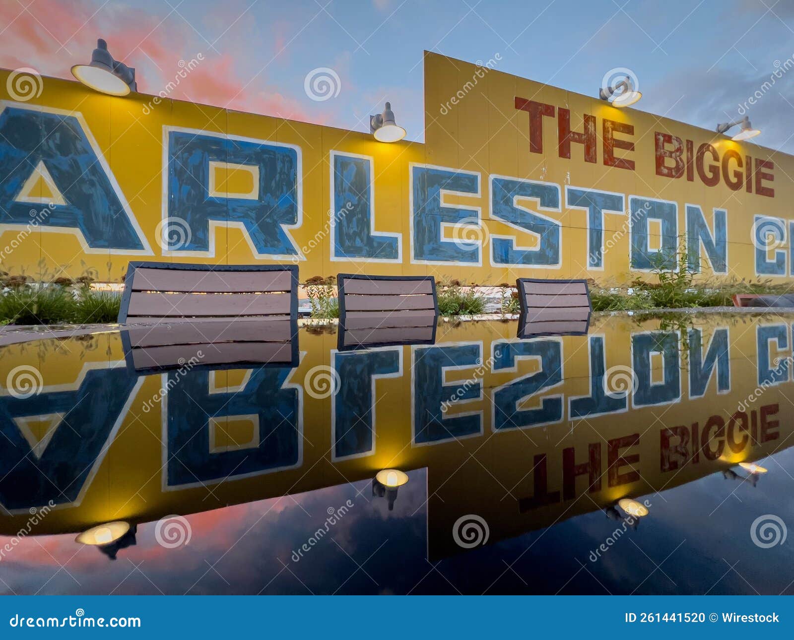 Sign on Top of a Building with Reflection on a Table at Sunset ...
