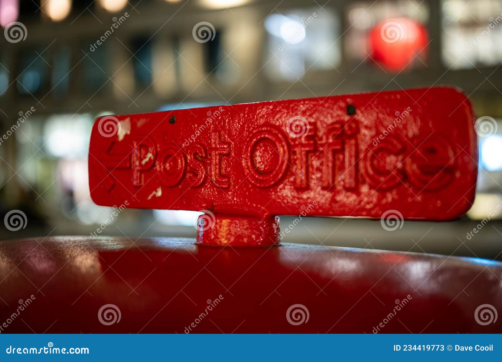 A Sign on Top of a Traditional British Red Post Box Pointing Towards a ...