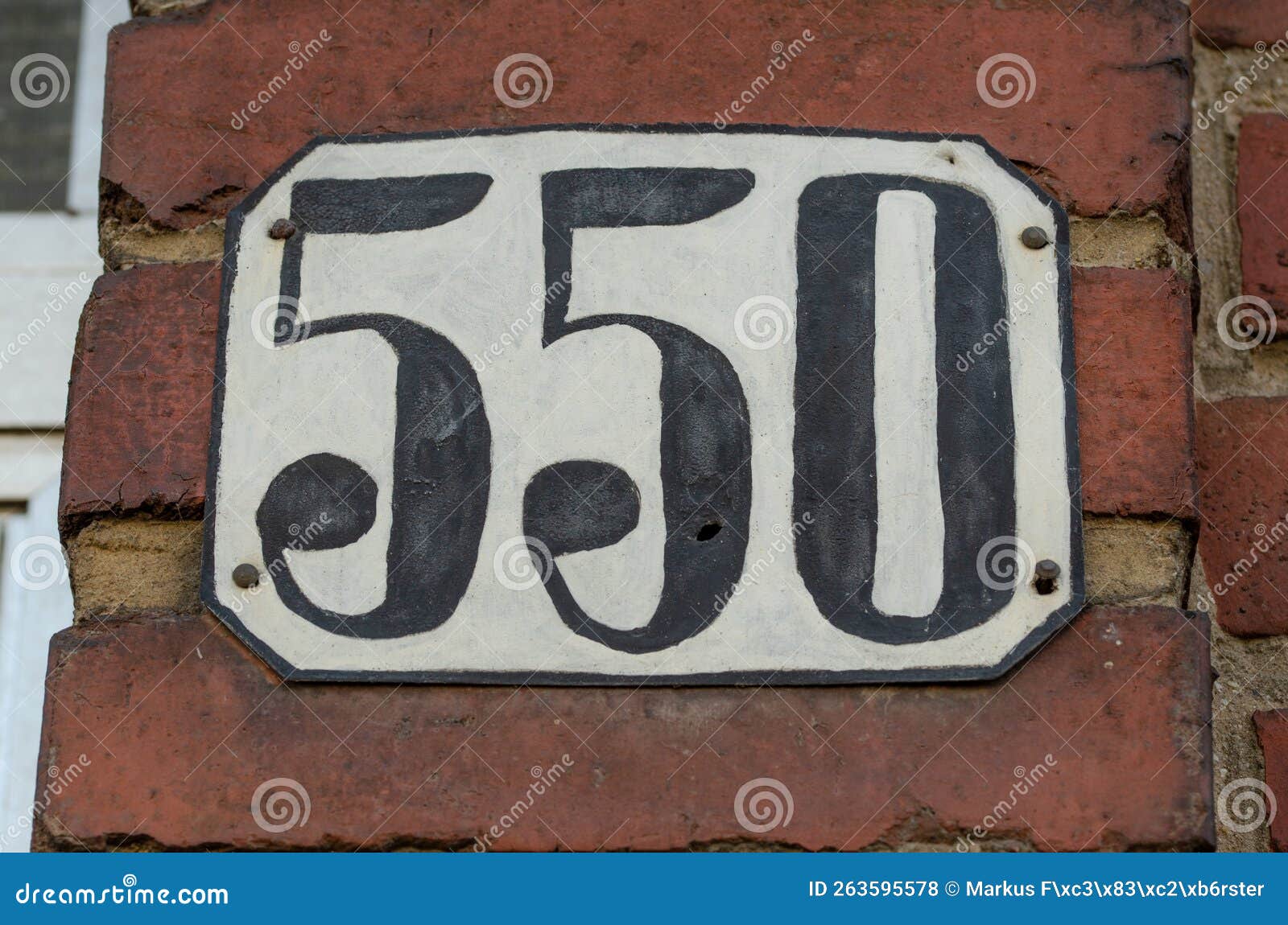 A Sign on a Wall with the Number Five Hundred Fifty Stock Photo - Image ...