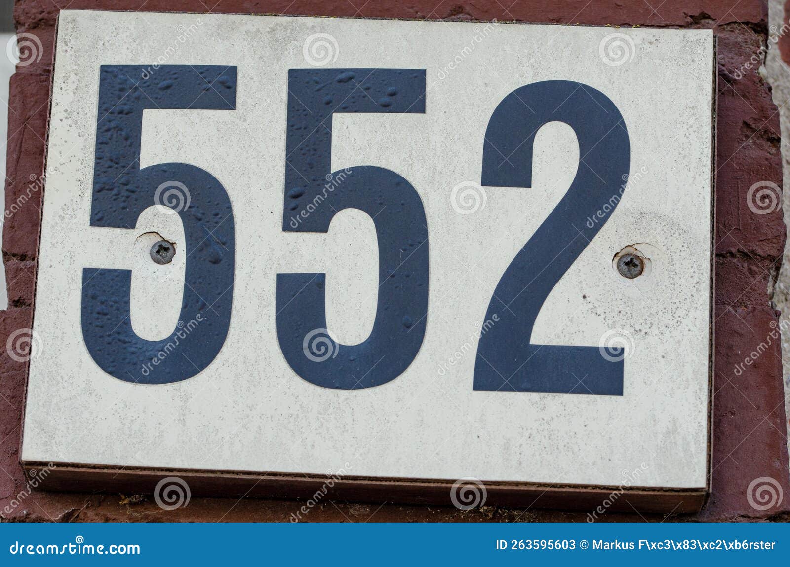A Sign on a Wall with the Number Five Hundred Fifty-two- Stock Image ...