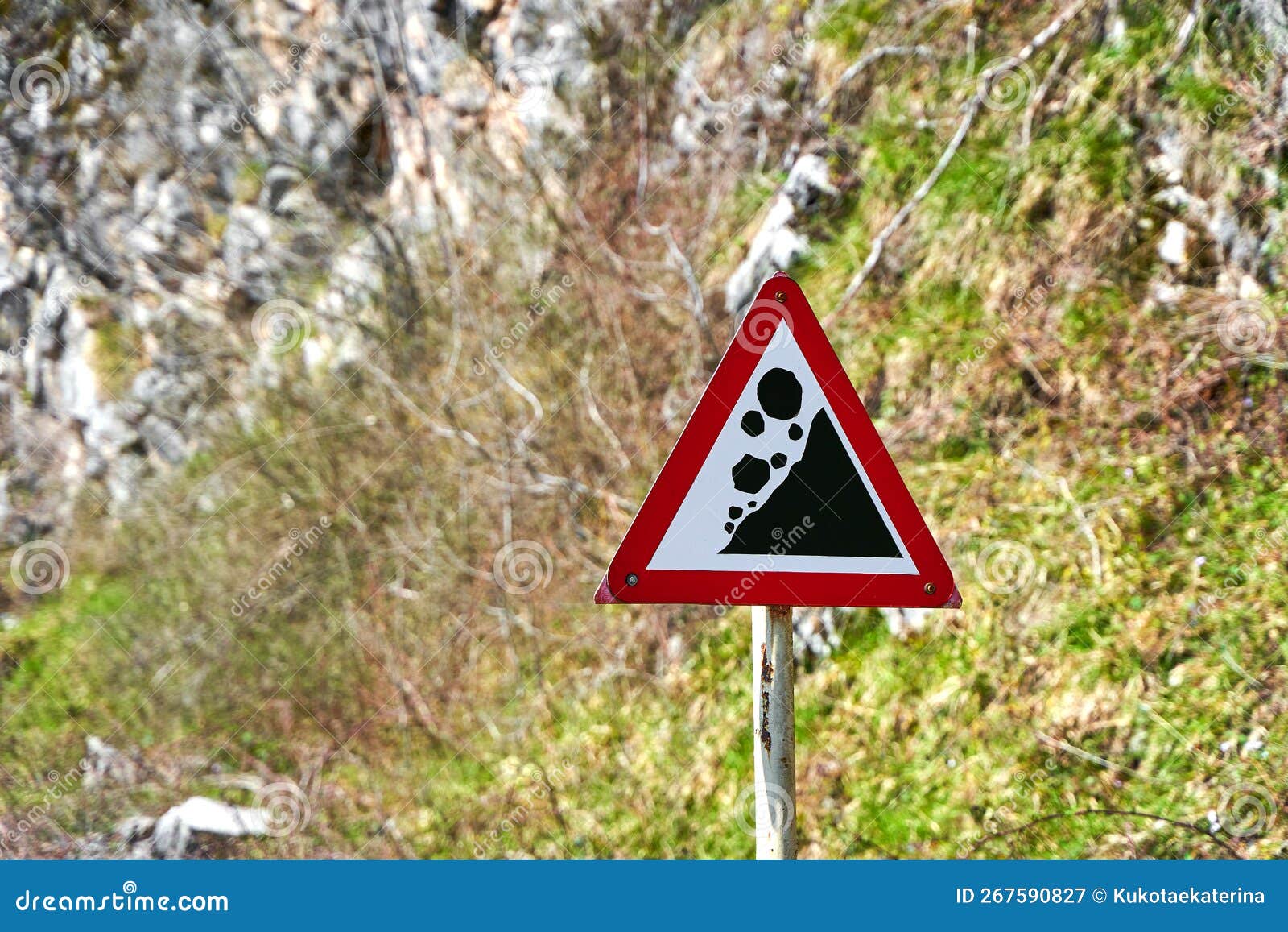 A Sign Warning of Rock Falls Along a Highway in the Mountains Stock ...