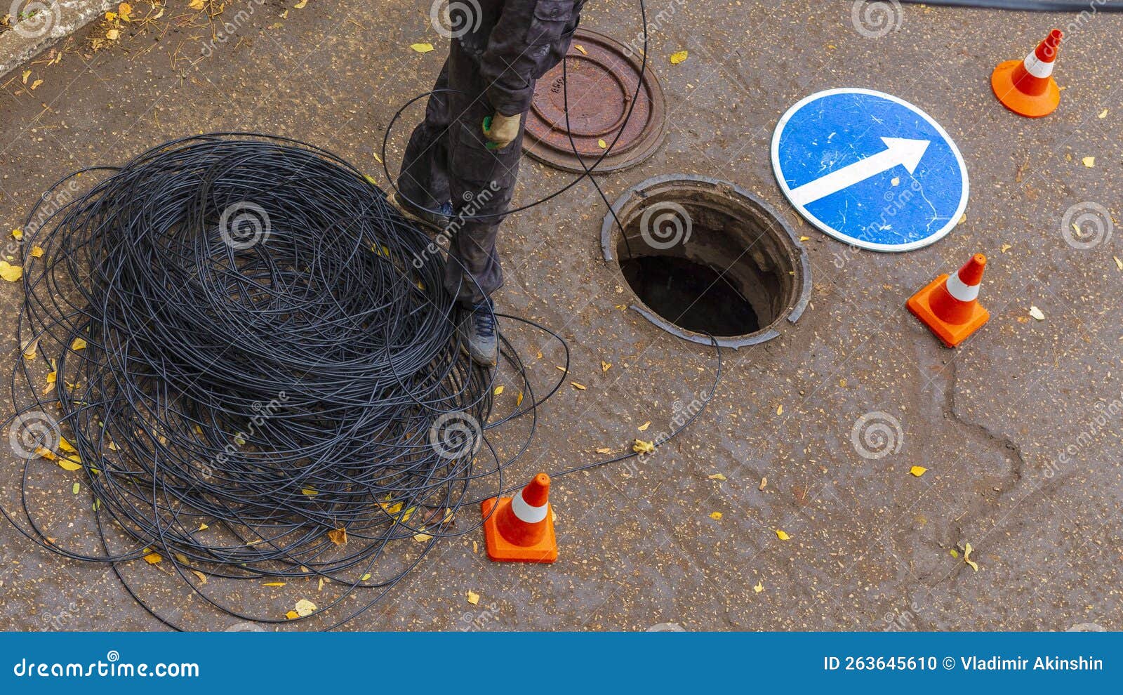 Signalman Worker Pulling an Electric Cable through the City Well Stock ...