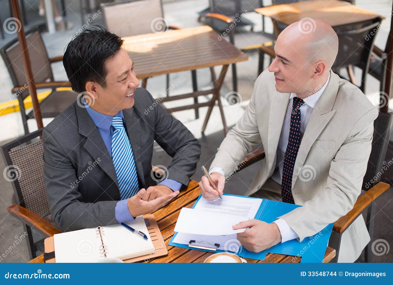 Signing a contract stock photo. Image of cafe, lifestyle - 33548744