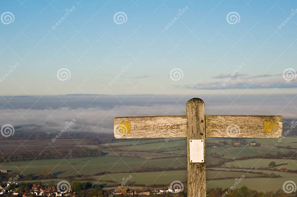 Signpost in Front of Countryside Landscape Stock Image - Image of ...