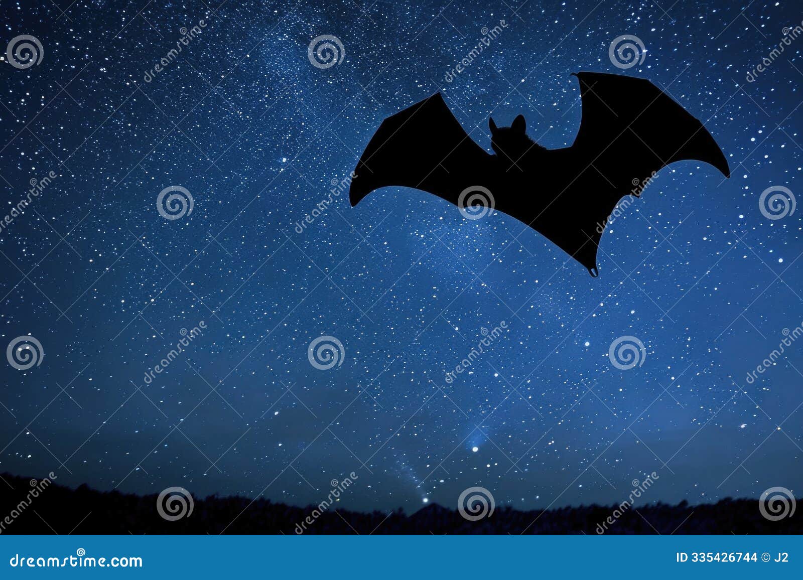 Silhouette of a Bat Flying Against a Starry Night Sky with Galaxy View ...