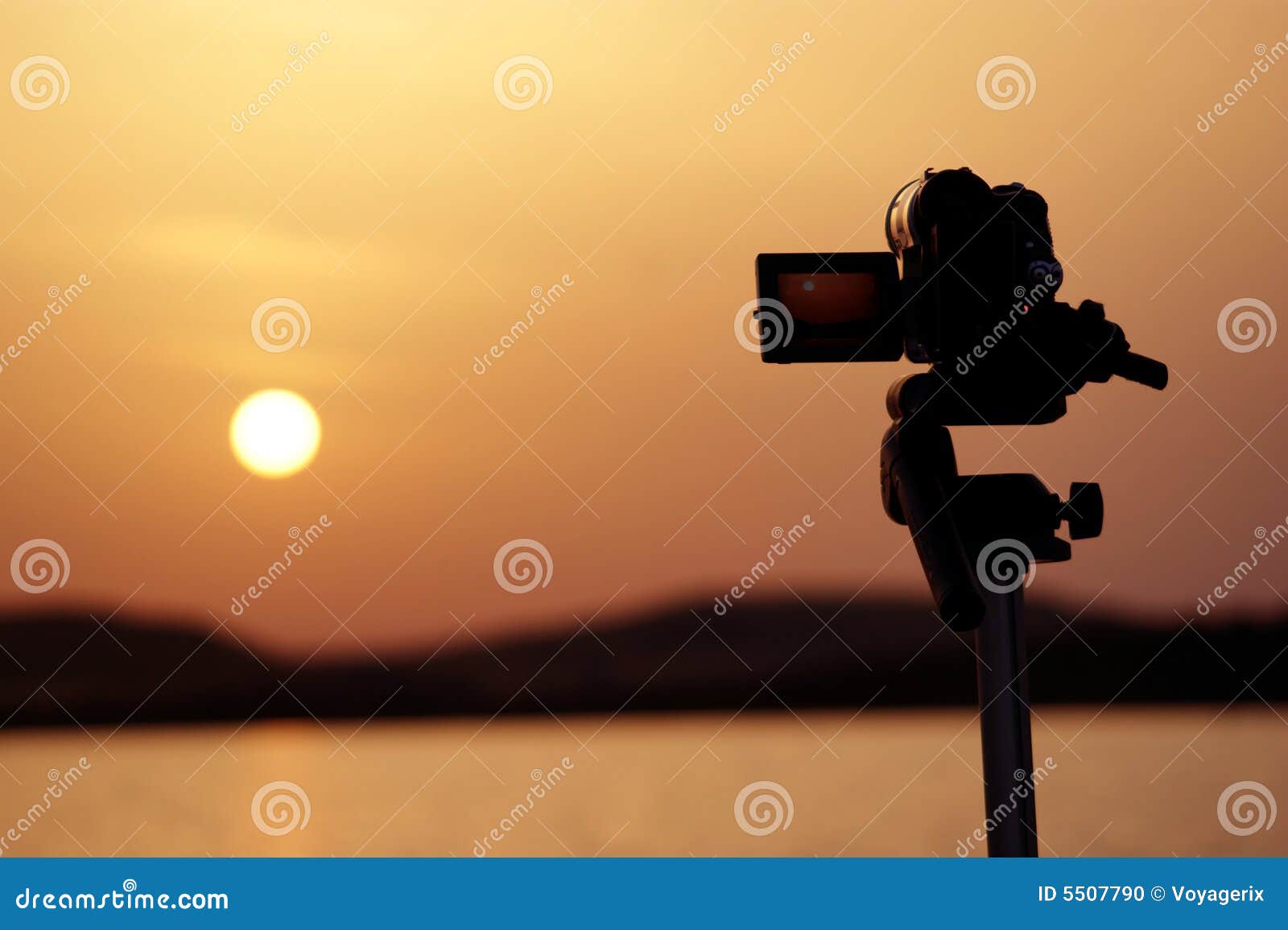 Silhouette of a Camera Taking Videos of a Sunset Stock Photo - Image of ...