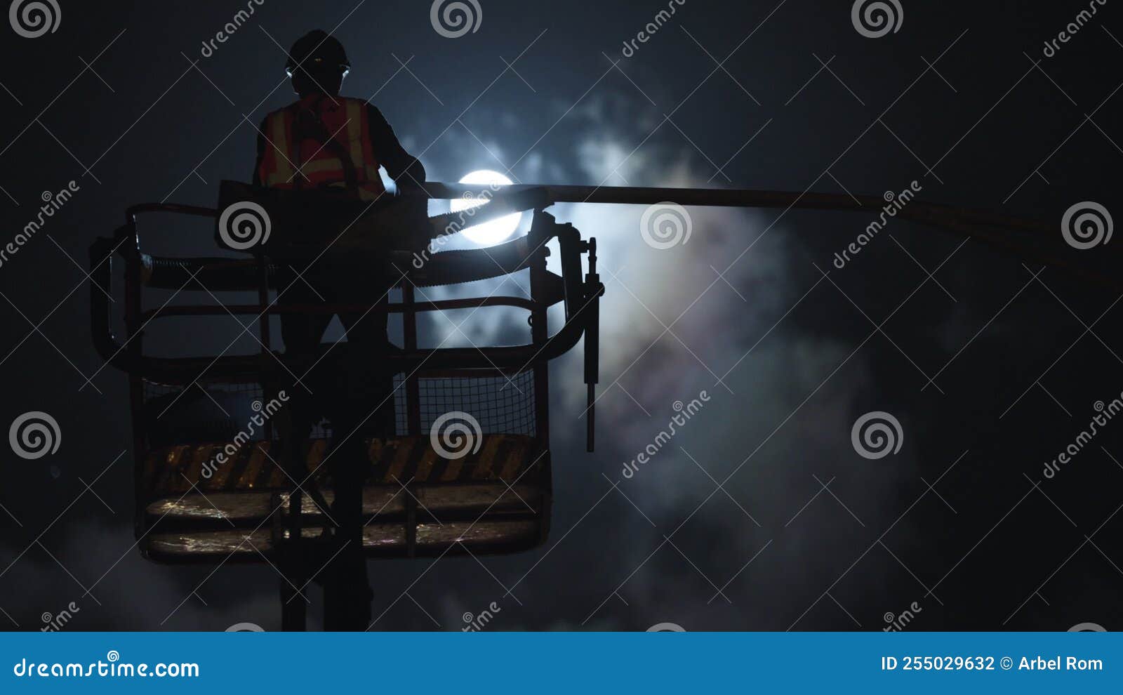 Silhouette of a Electric Engineer Working on a Street Lamp with the ...