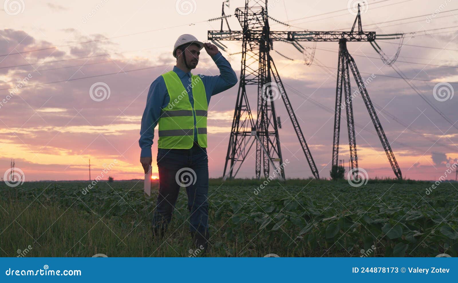 Silhouette of an Electrical Engineer in Hard Hat at Sunset with Tablet ...