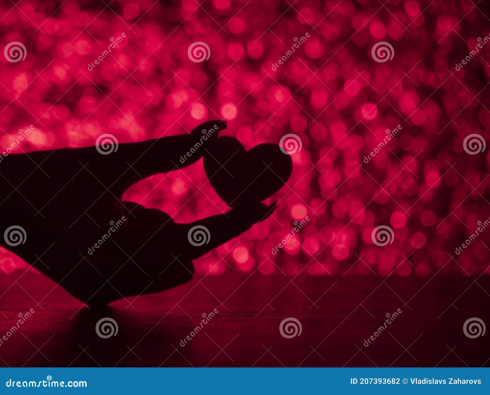 Silhouette of a Female Hand on a Table Holding Stock Photo - Image of ...