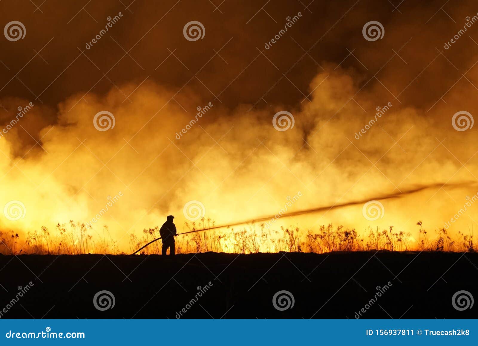 Silhouette of Fireman Fighting Bushfire at Night, Man Against the Fire ...