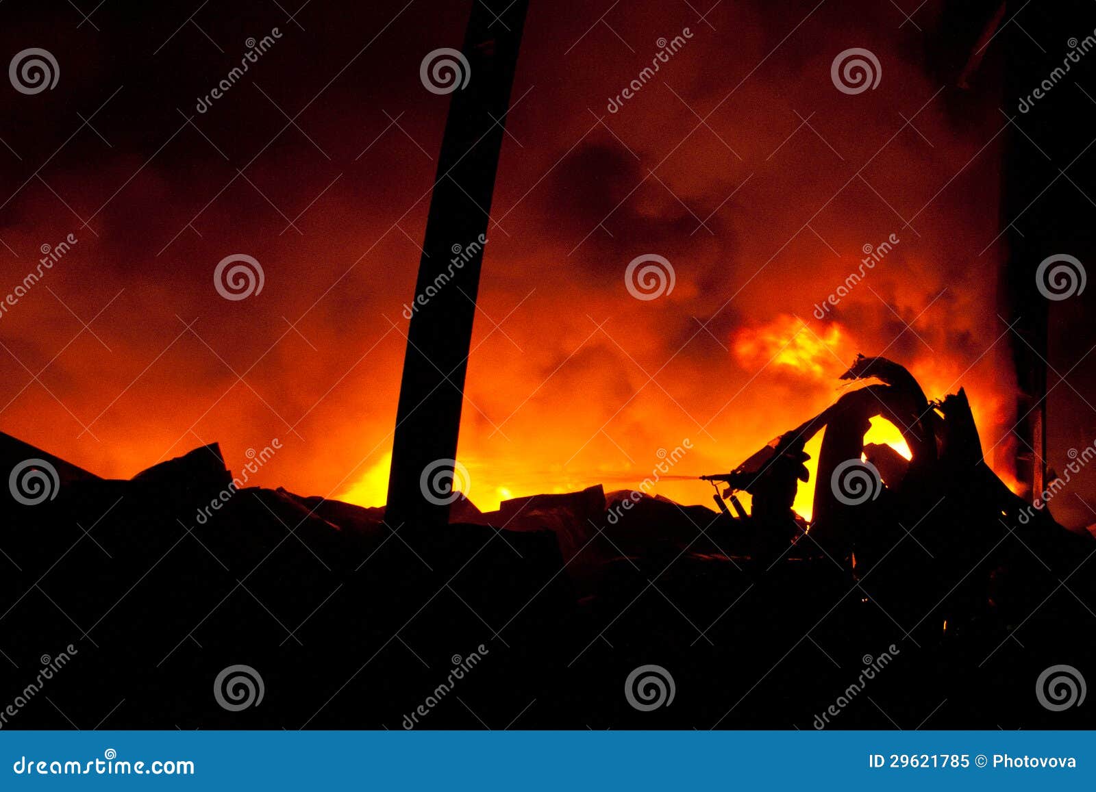 Silhouette of Firemen Fighting a Raging Fire with Huge Flames Stock ...