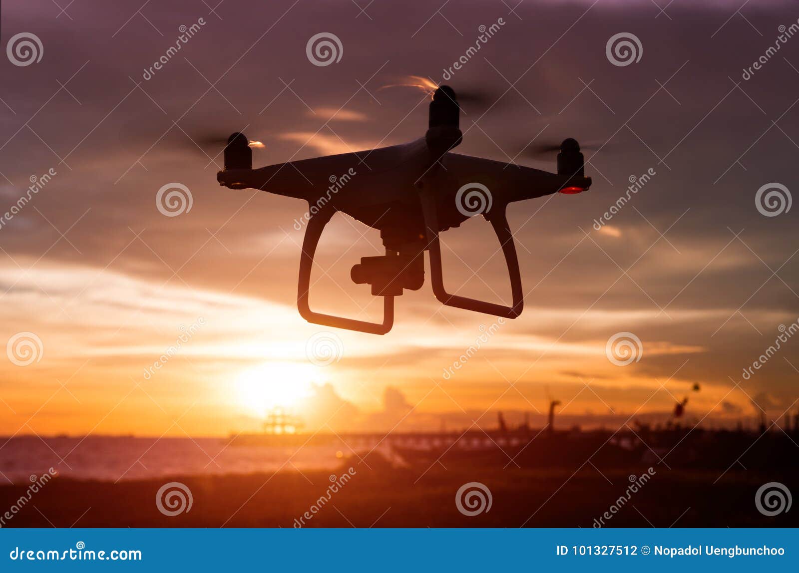 Silhouette of Flying Drone in Sunset Time. Stock Photo - Image of ...