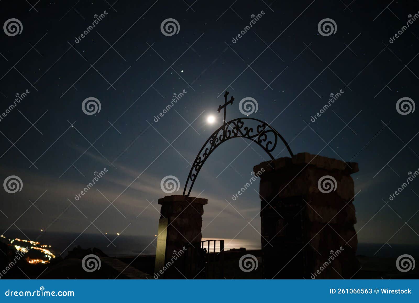 Silhouette of a Gate Entrance with a Cross on Top in the Nighttime ...
