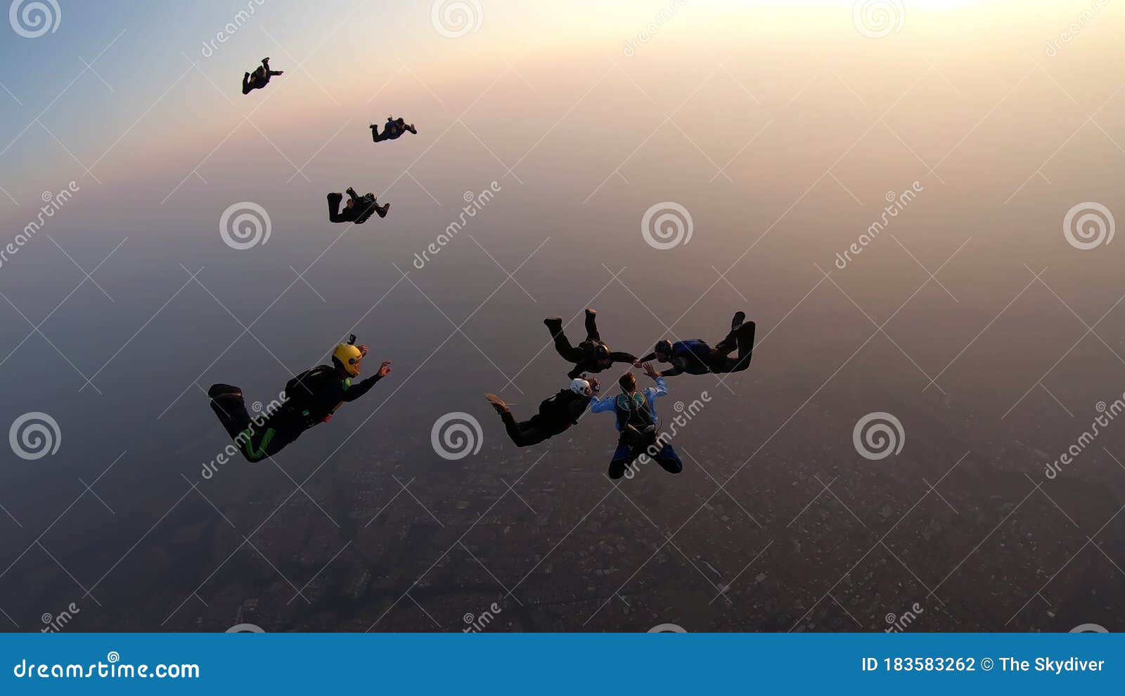 Silhouette of a Group of Skydivers Jumping at the End of the Day. Stock ...