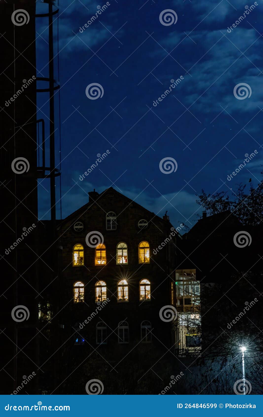 Silhouette of a House with Illuminated Windows on a Moonlit Night Stock ...