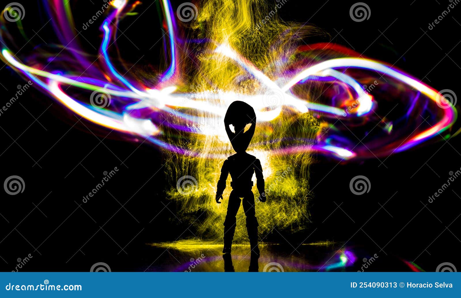 Silhouette of a Humanoid with an Alien Head Surrounded by Colored ...