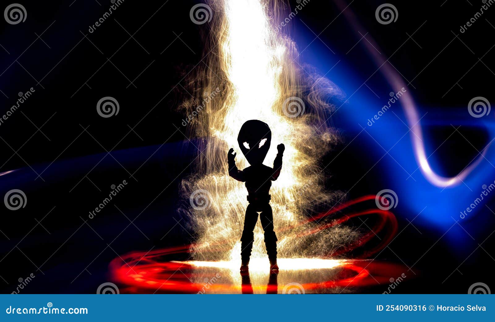 Silhouette of a Humanoid with an Alien Head Surrounded by Colored ...