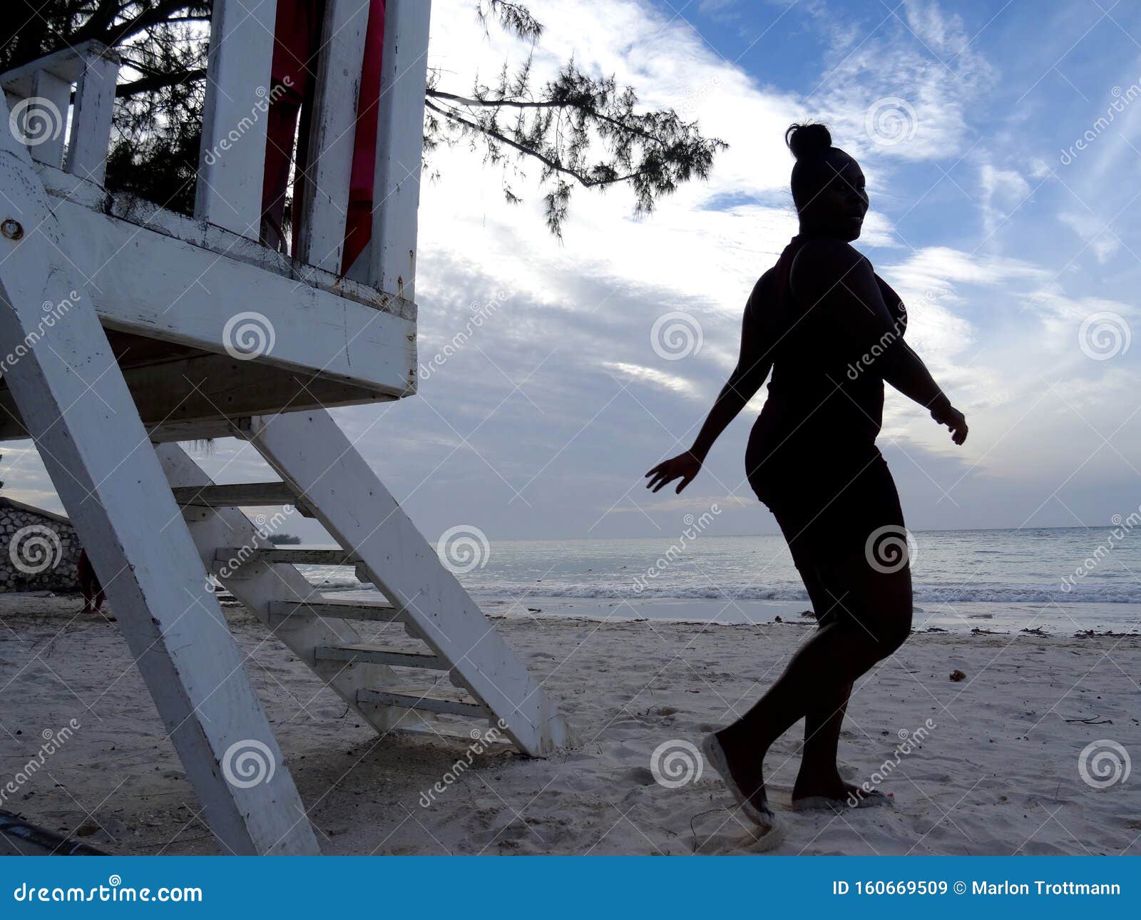 Silhouette Of A Jamaican Woman Walking On A Beach Editorial Stock Image