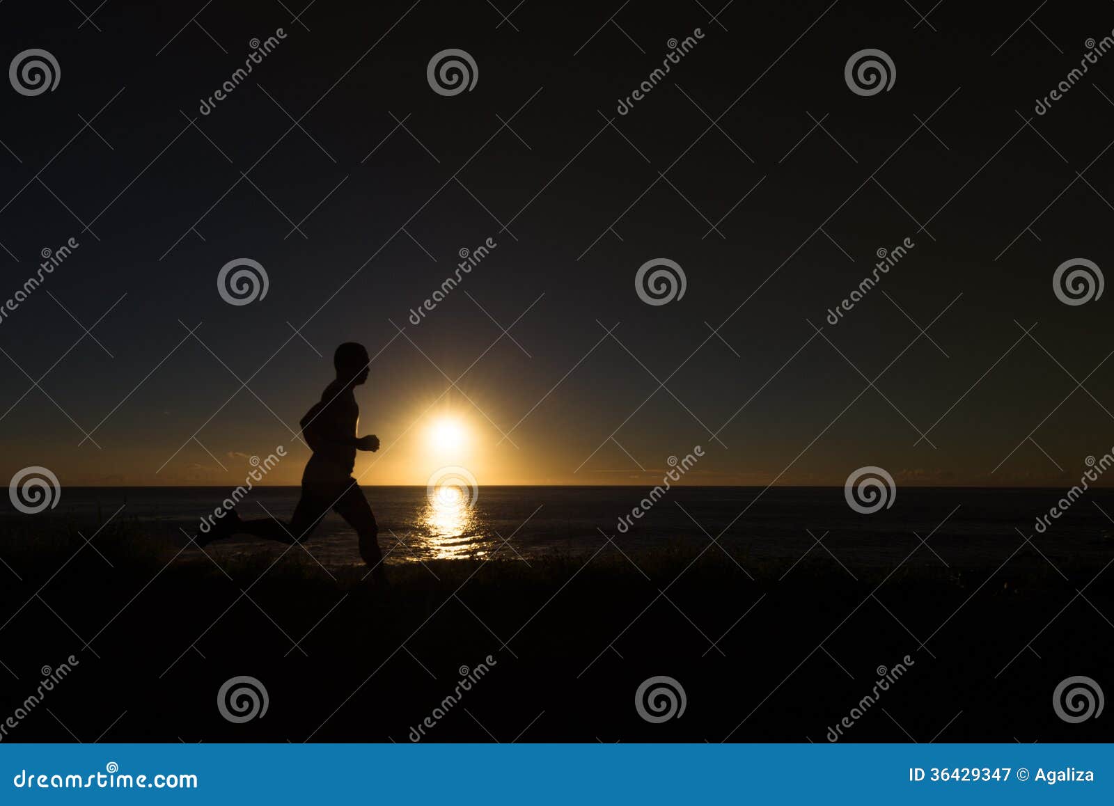 Silhouette of Jogger Along Ocean Horizon at Sunset Stock Image - Image ...